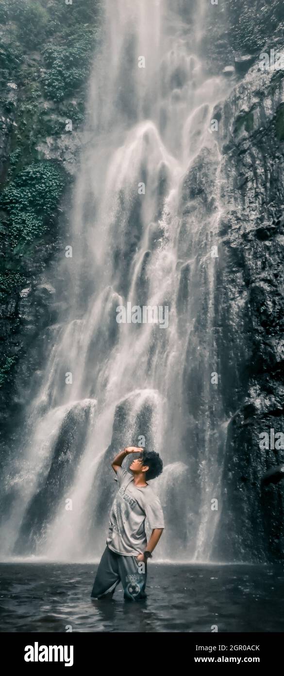 Full Length Of Man Splashing Water In Sea Stock Photo - Alamy