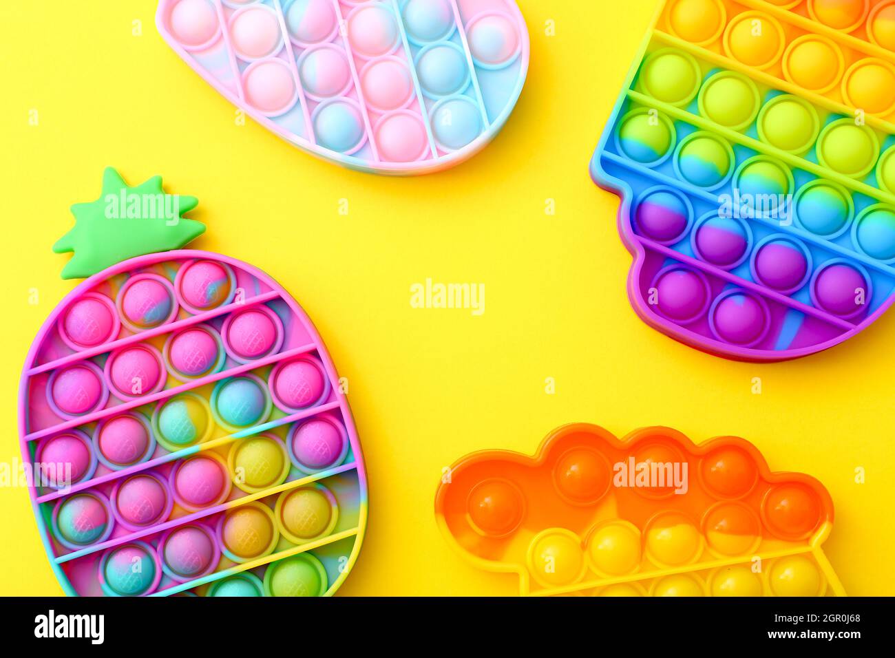 Close up of colorful antistress sensory toy fidget push pop it on ...