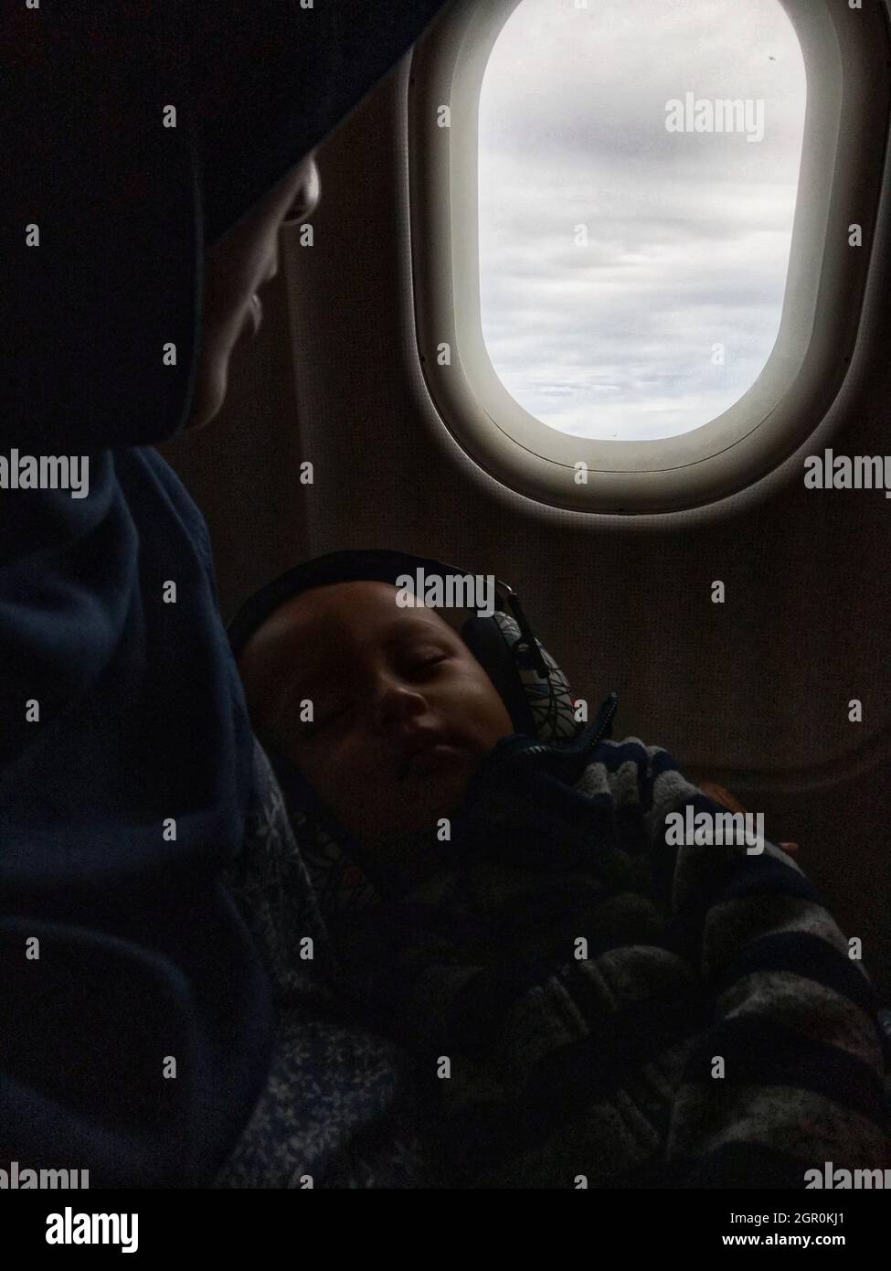 Boy Sleeping On Airplane Window Stock Photo - Alamy