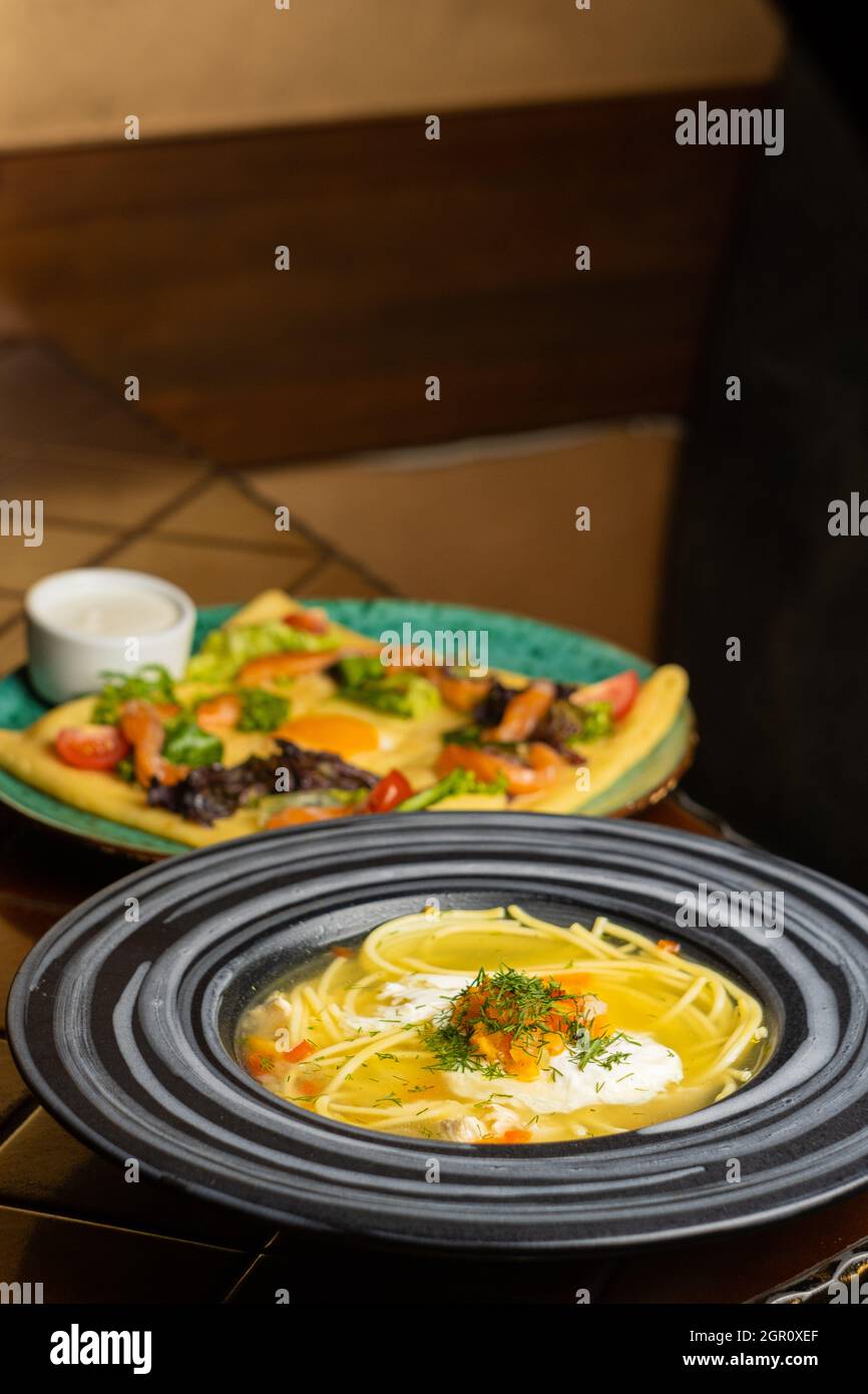 Vegetable spaghetti soup and a tasty crepe with vegetables and an egg ...