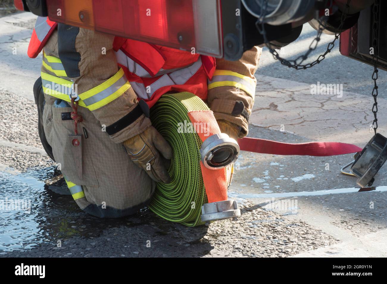 Rolling up fire hose hi-res stock photography and images - Alamy