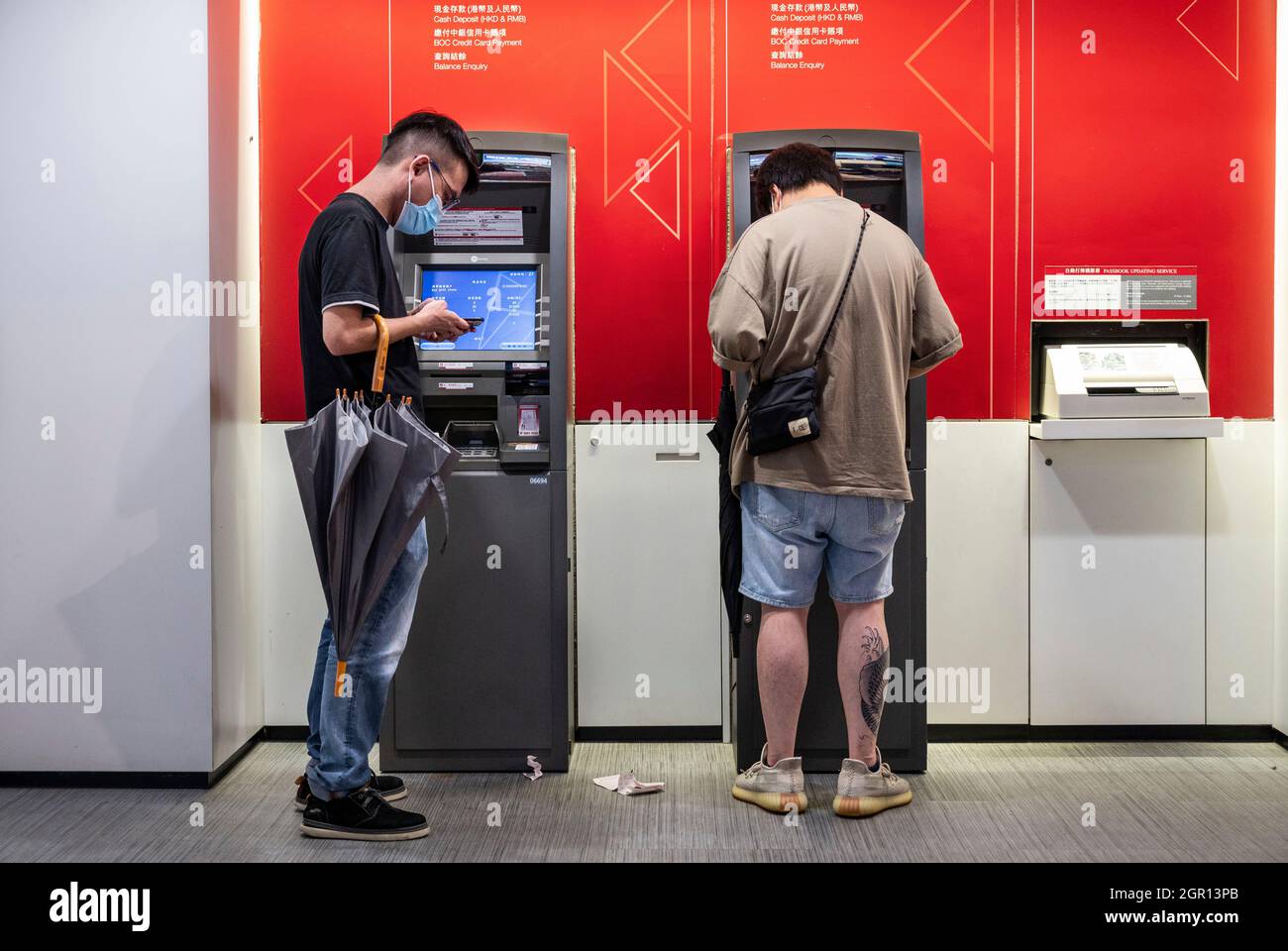 Hong Kong, China. 23rd Sep, 2021. Customers withdraw money from an ATM machine at the Chinese ...