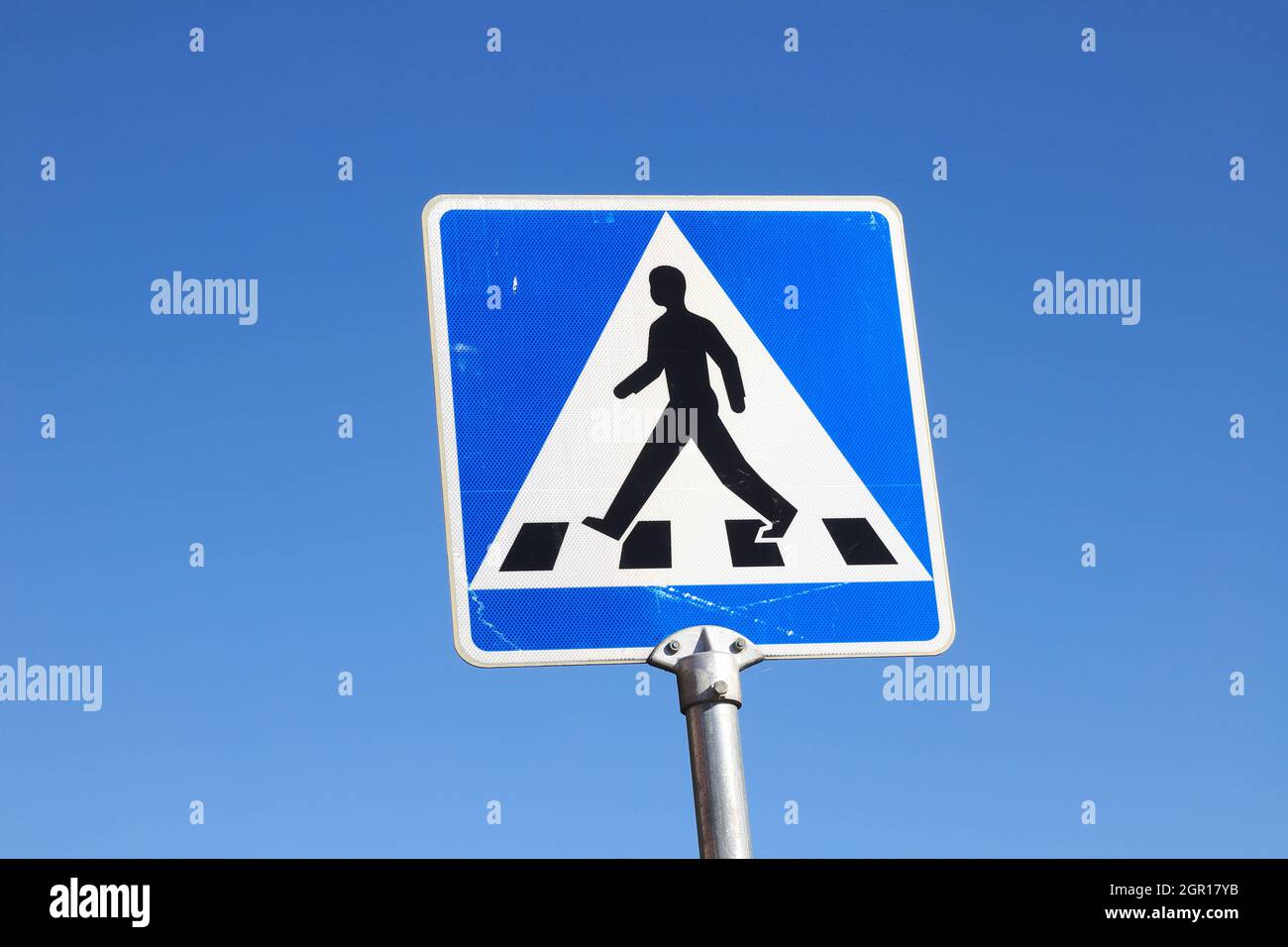 Crosswalk road sign isolated aganist a blue clear sky Stock Photo - Alamy