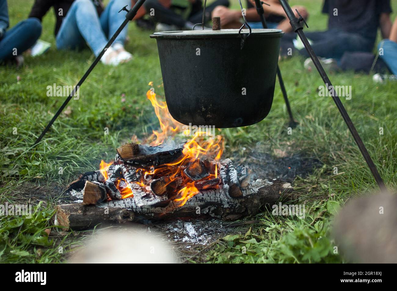 Dark big pot or cauldron, cooking pan with boiling water inside above ...