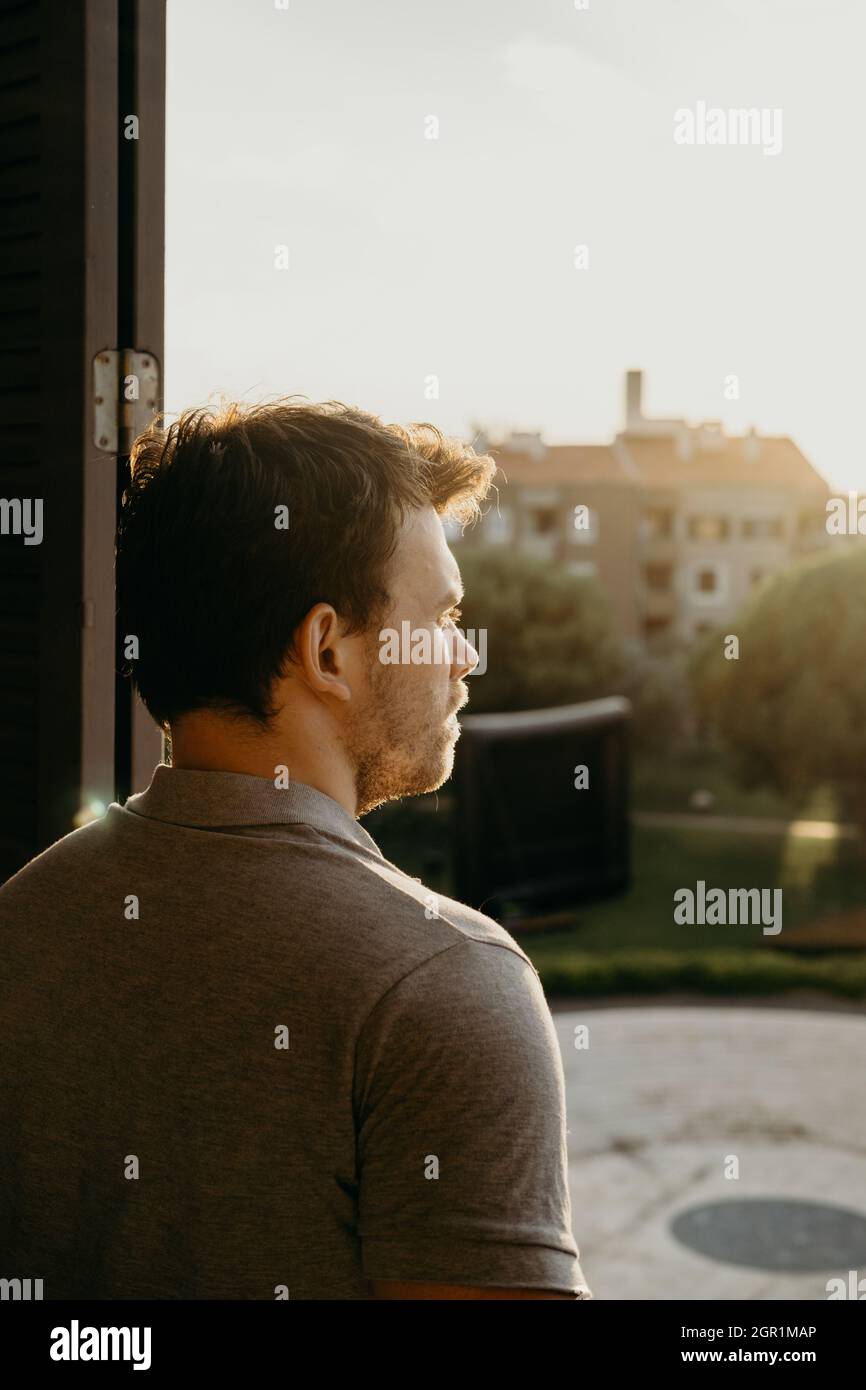 Man looking out of the window Stock Photo - Alamy