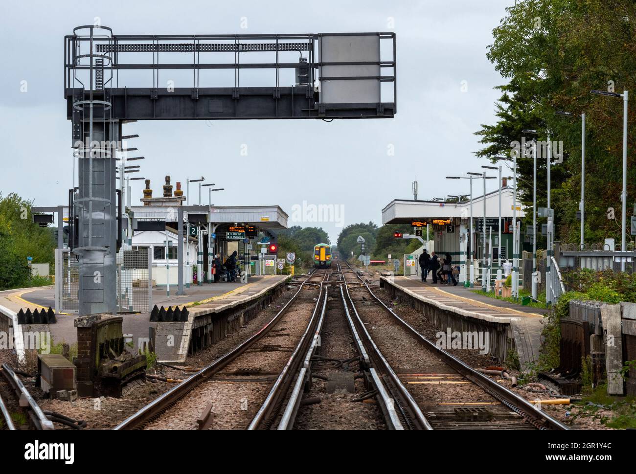 looking along railway tracks at a train in barnham railway train ...