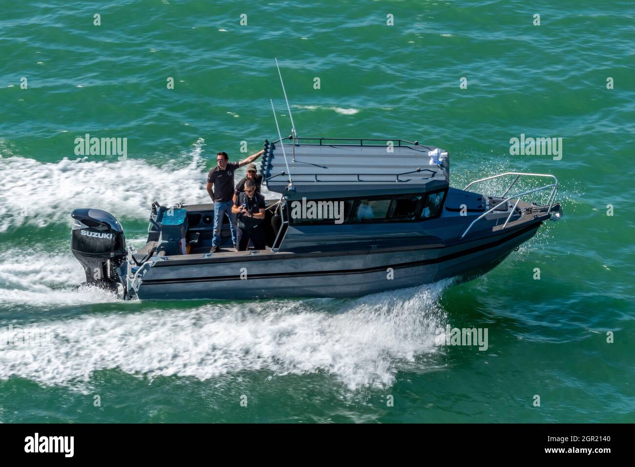 modern fast fishing boat with an outboard engine with fishermen ...