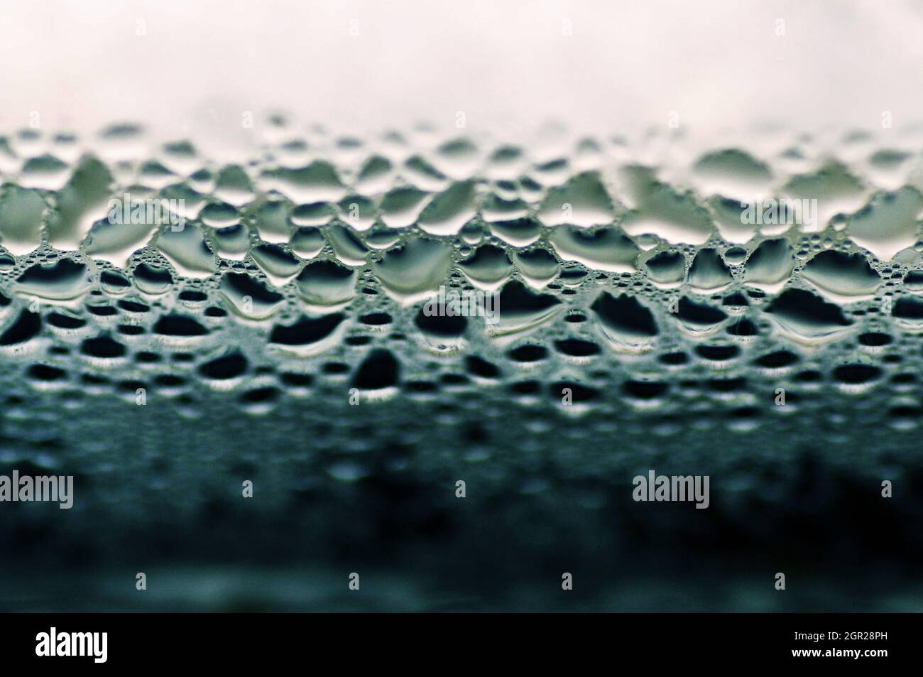 Condensed water drops on glass windscreen in blue color Stock Photo - Alamy