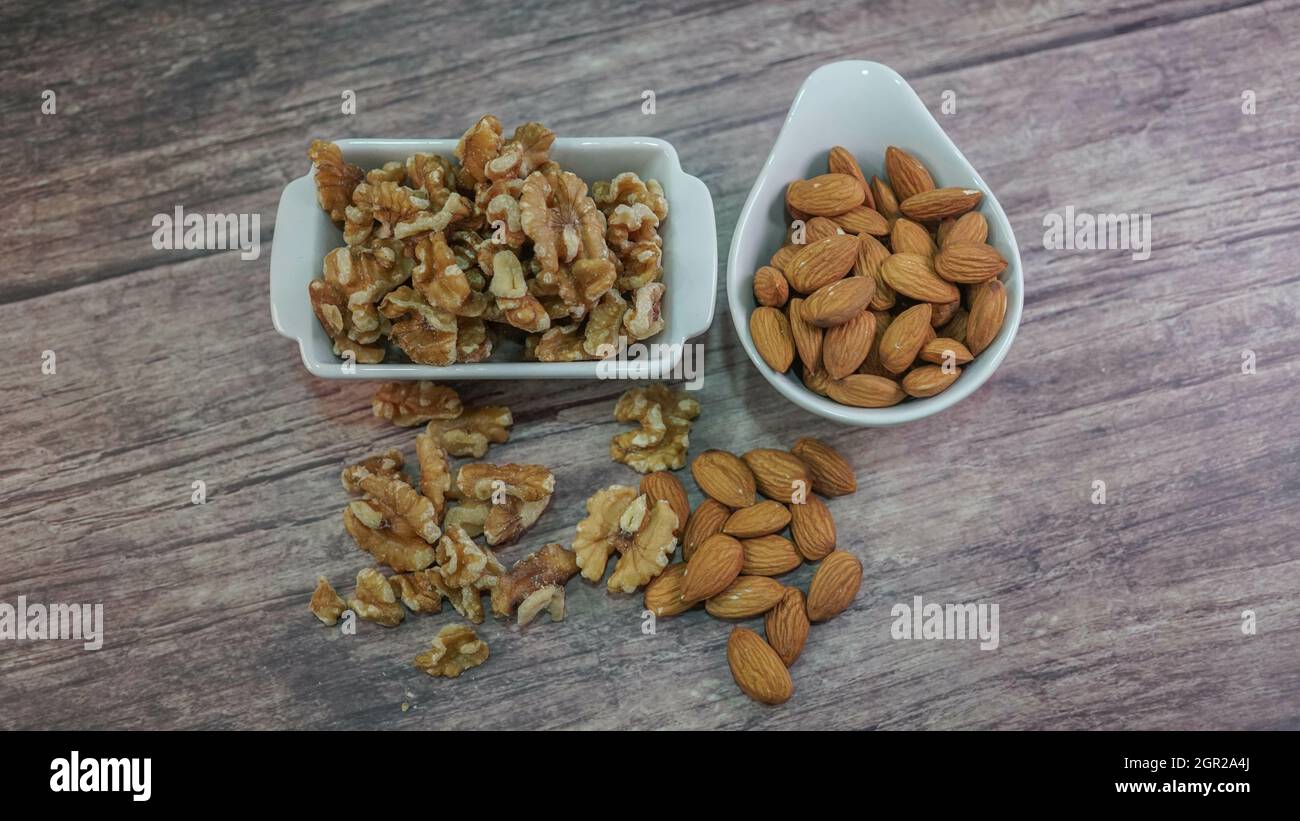 Walnuts and Almonds in white bowls Stock Photo - Alamy