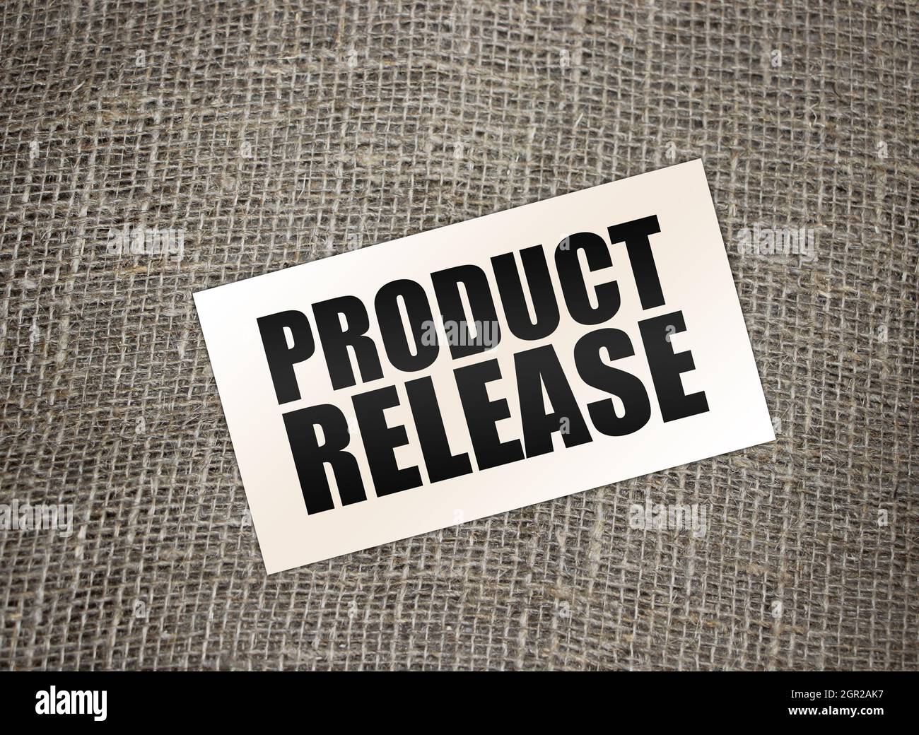 NEW RELEASE text on card on burlap canvas. business startup concept ...