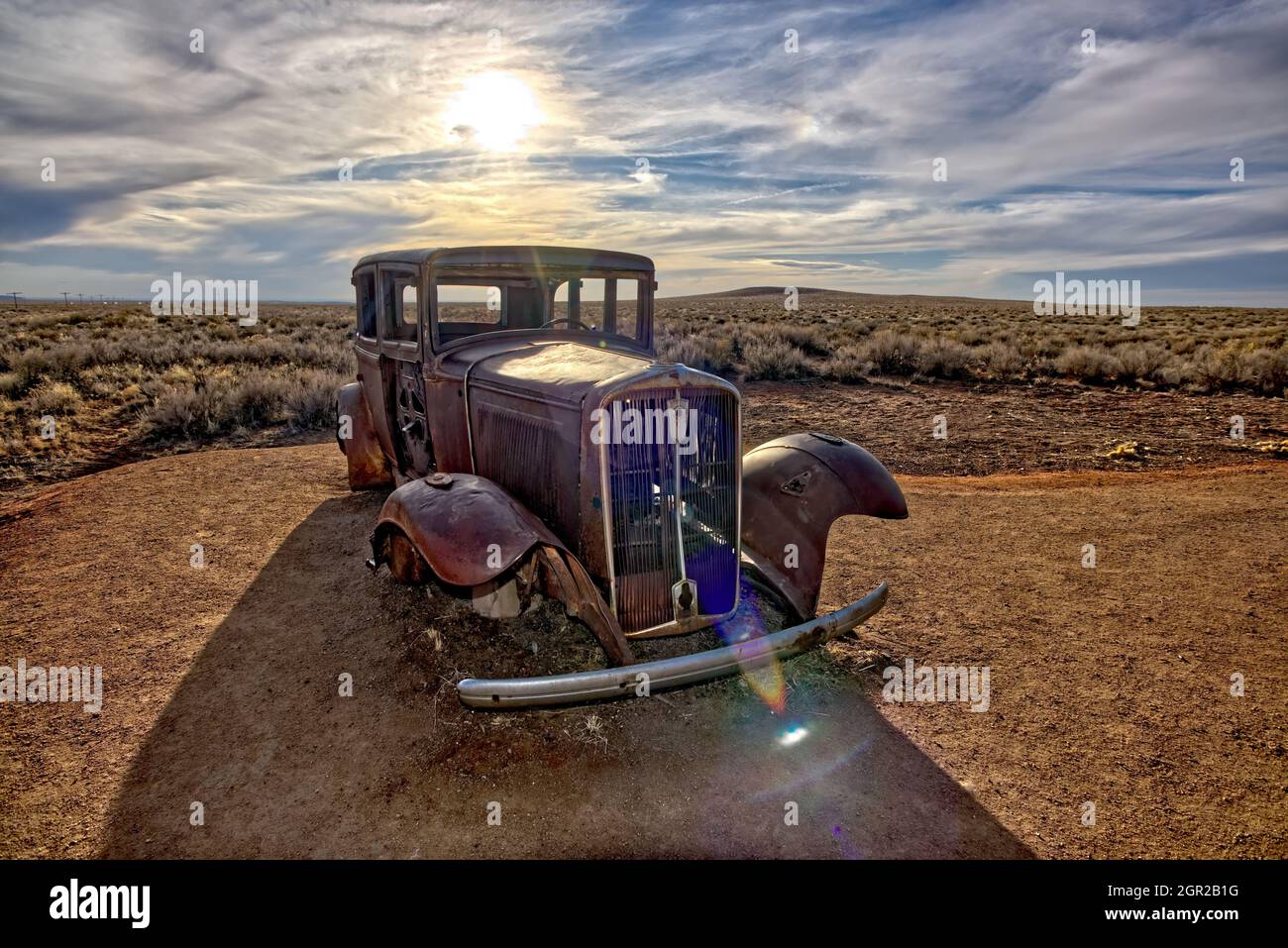 The shell of an old Model-T Car mounted on concrete pillars marking the ...