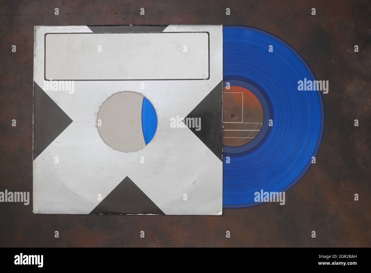 Aged black paper cover and blue vinyl LP record isolated on rusty ...