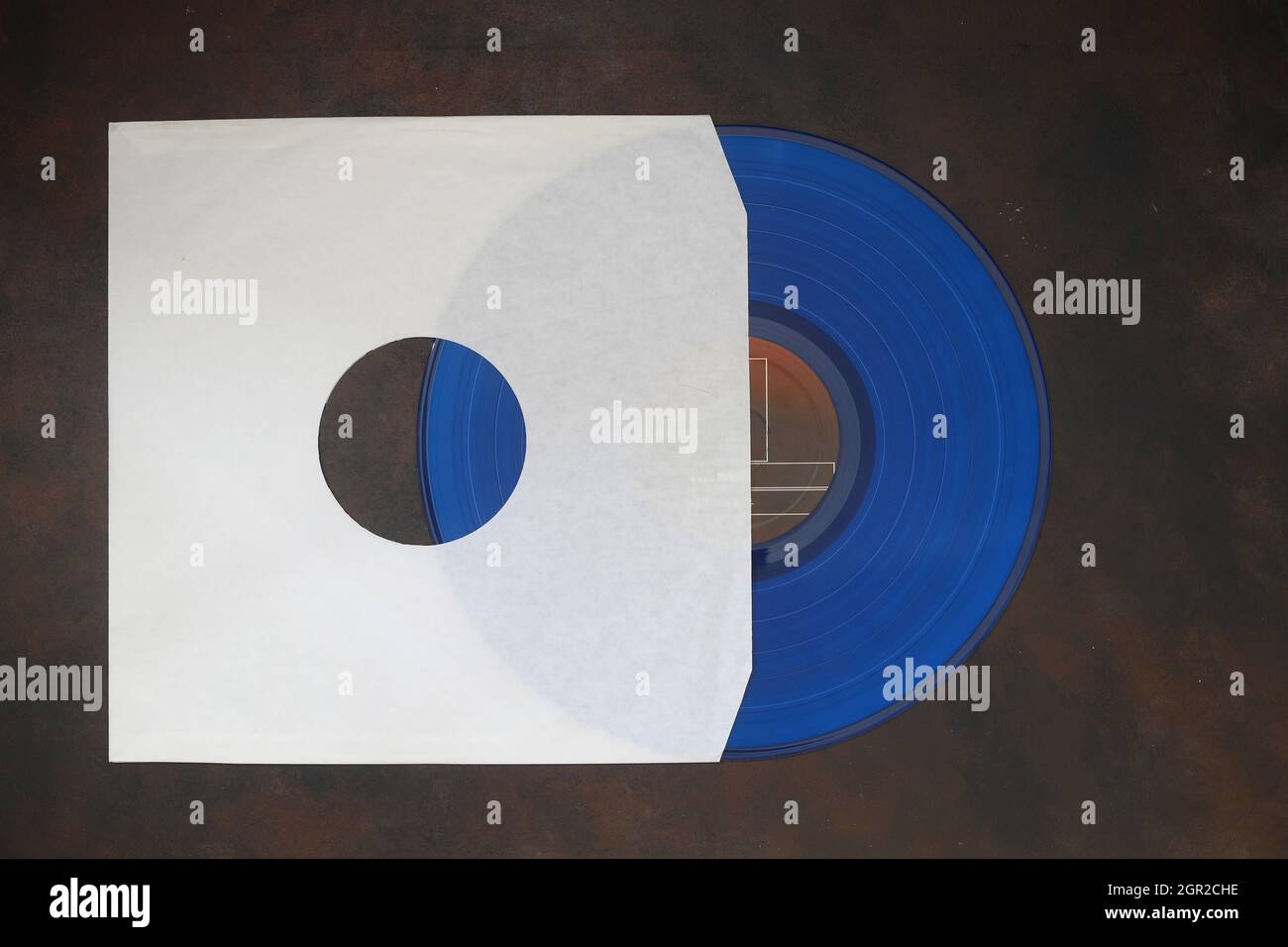 Aged White paper cover and blue vinyl LP record isolated on rusty ...