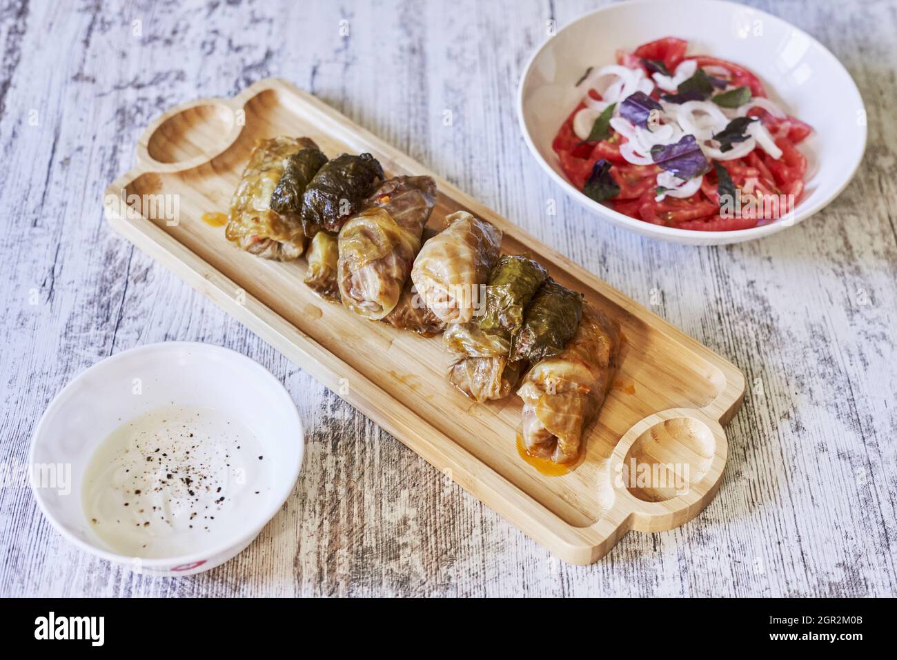 Different types of dolmas with a delicious salad and sauce Stock Photo ...