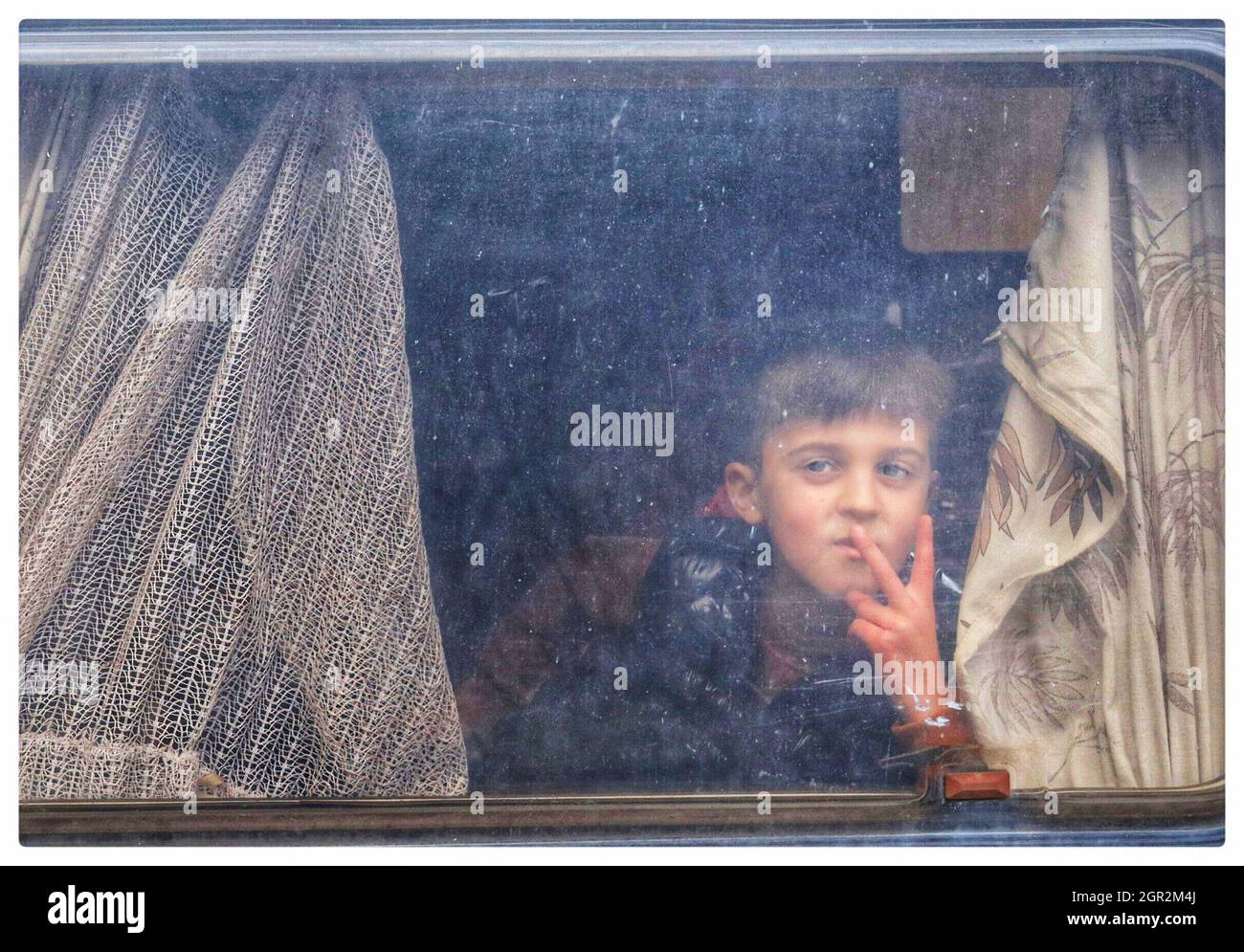 Boy looking into store window Cut Out Stock Images & Pictures - Alamy