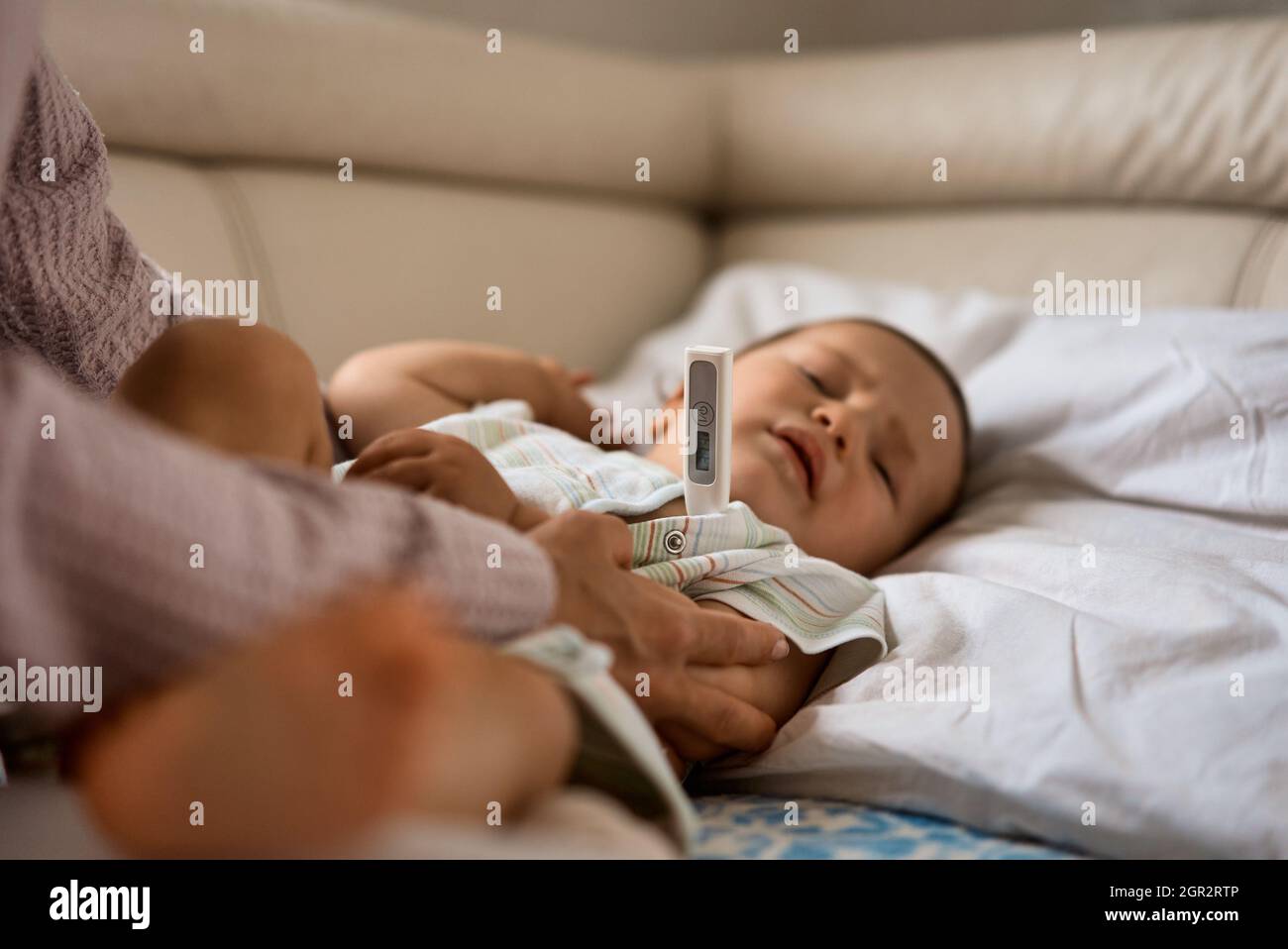 The little boy cry because of the high temperature. First year of life ...