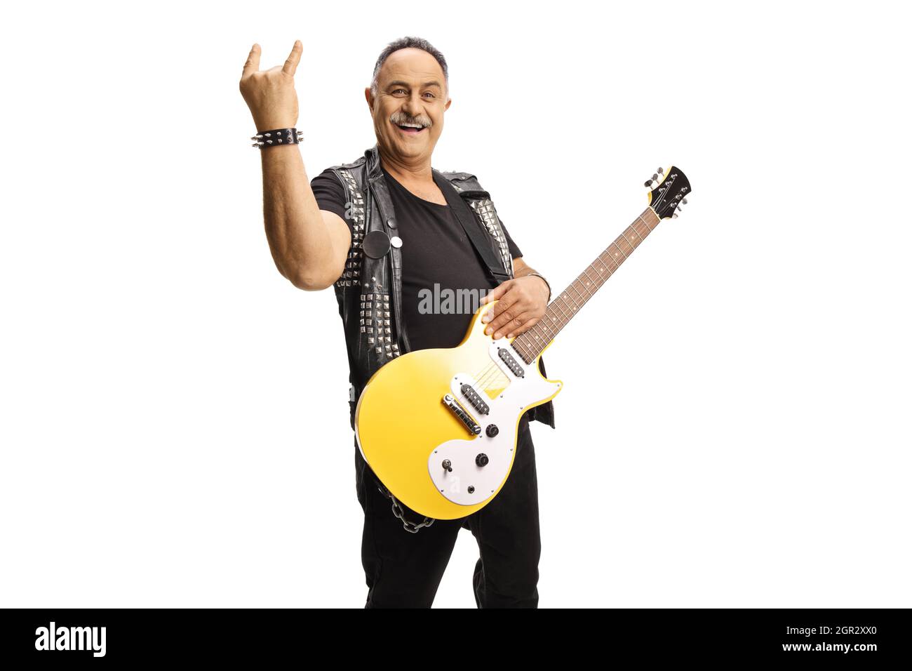 Mature rocker with an electric guitar gesturing a rock and roll sign ...