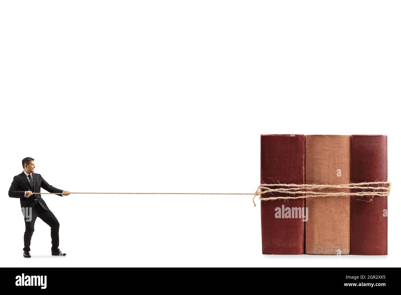 Full length profile shot of a businessman pulling a books tied with a ...