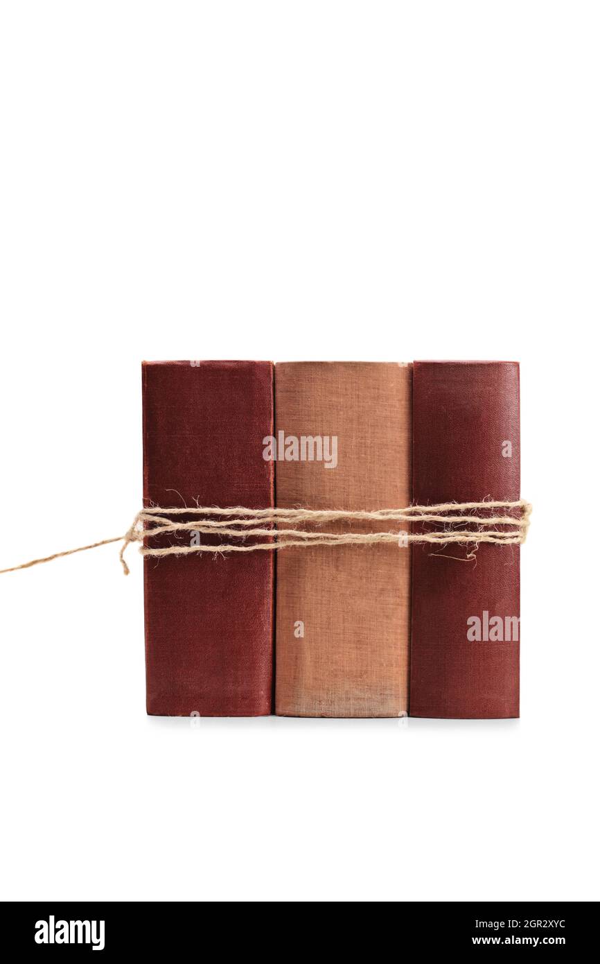 Studio shot of three books tied with a rope isolated on white ...