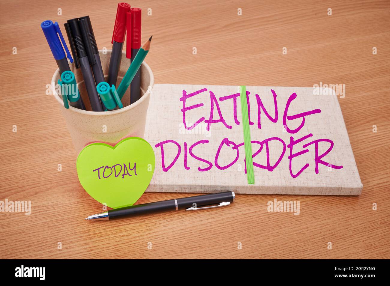 Hand writing sign Eating Disorder. Concept meaning illnesses that are ...