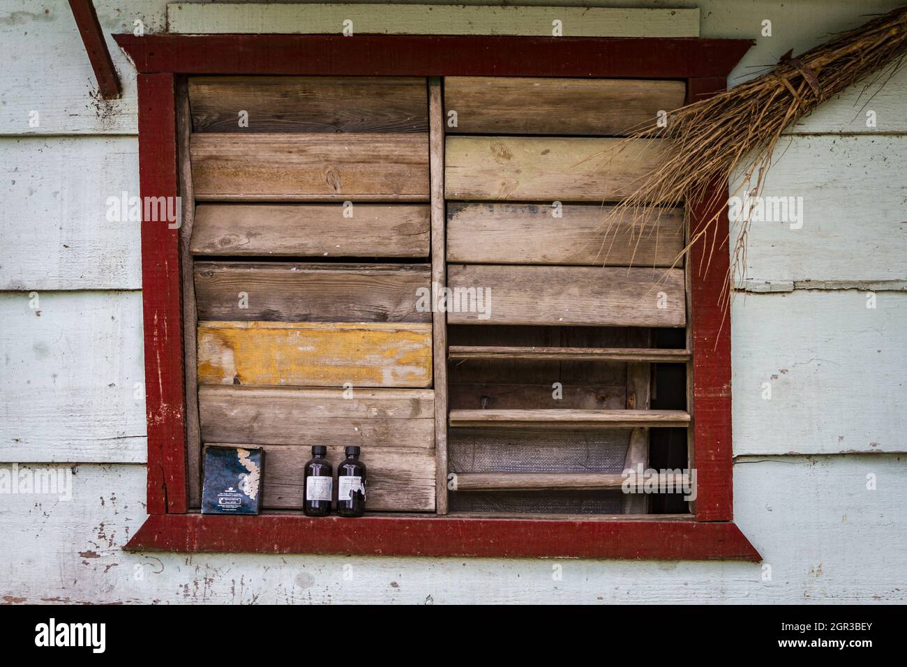 Window with a red window frame covered by wooden planks Stock Photo - Alamy
