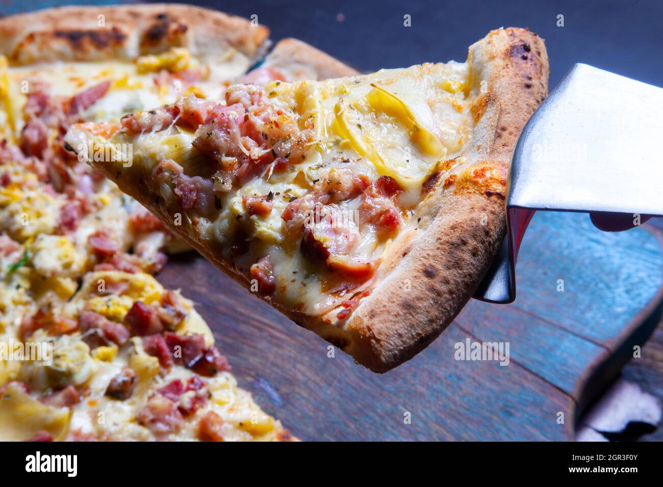 Pizza slice with mozzarella and bacon Stock Photo - Alamy
