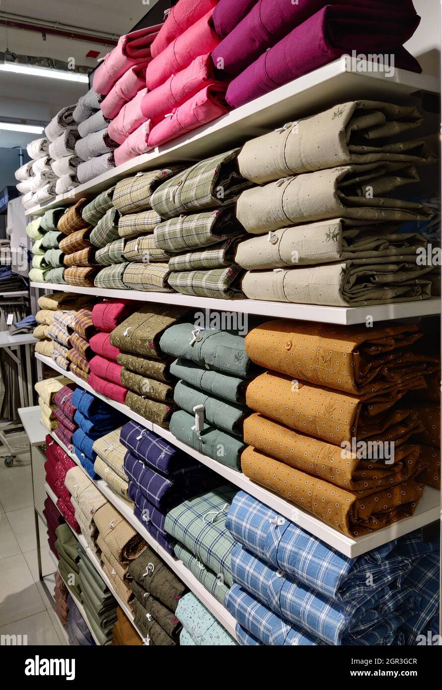 Different Coloured Bunches Of Shirts In Shopping Mall Stock Photo - Alamy