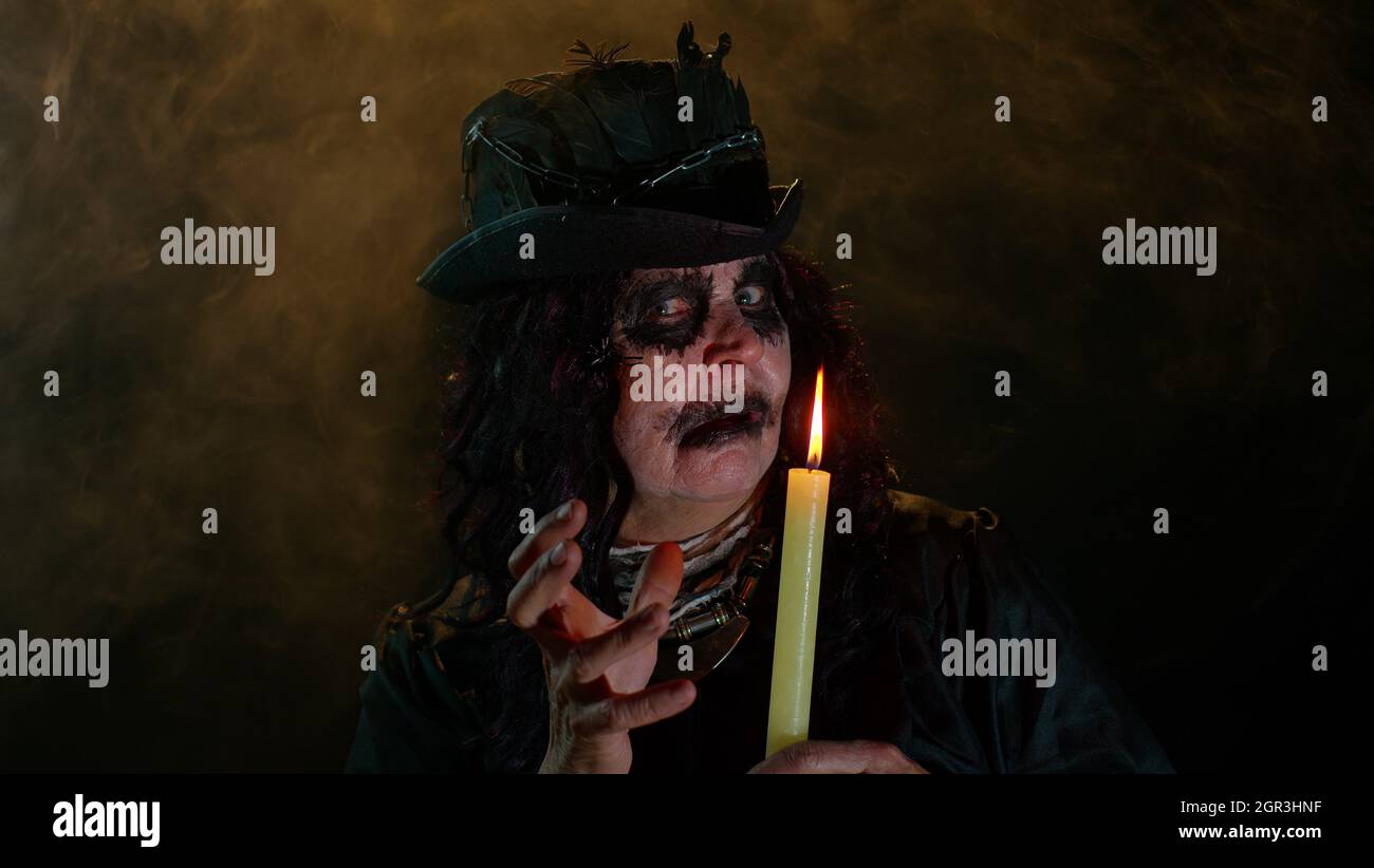 Creepy mature woman grandmother with Halloween stylish witch makeup ...