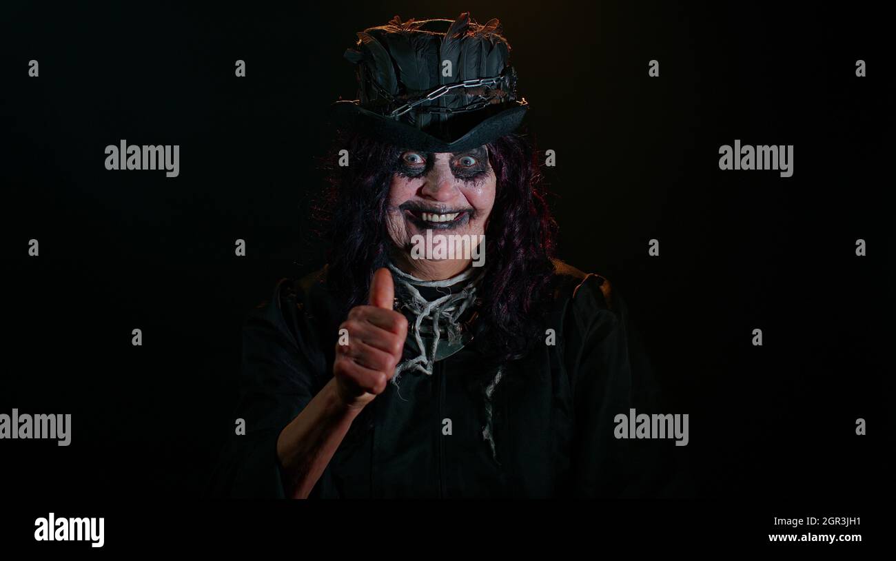 Sinister Elderly Woman With Scary Halloween Witch Makeup In Costume
