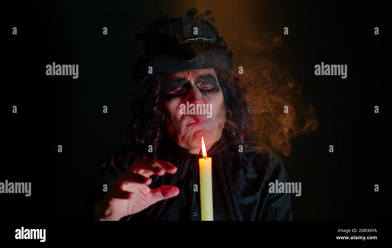 Sinister man with scary Halloween witcher makeup in costume making ...