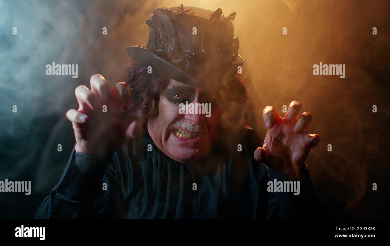 Sinister man with horrible scary Halloween witcher makeup in costume ...