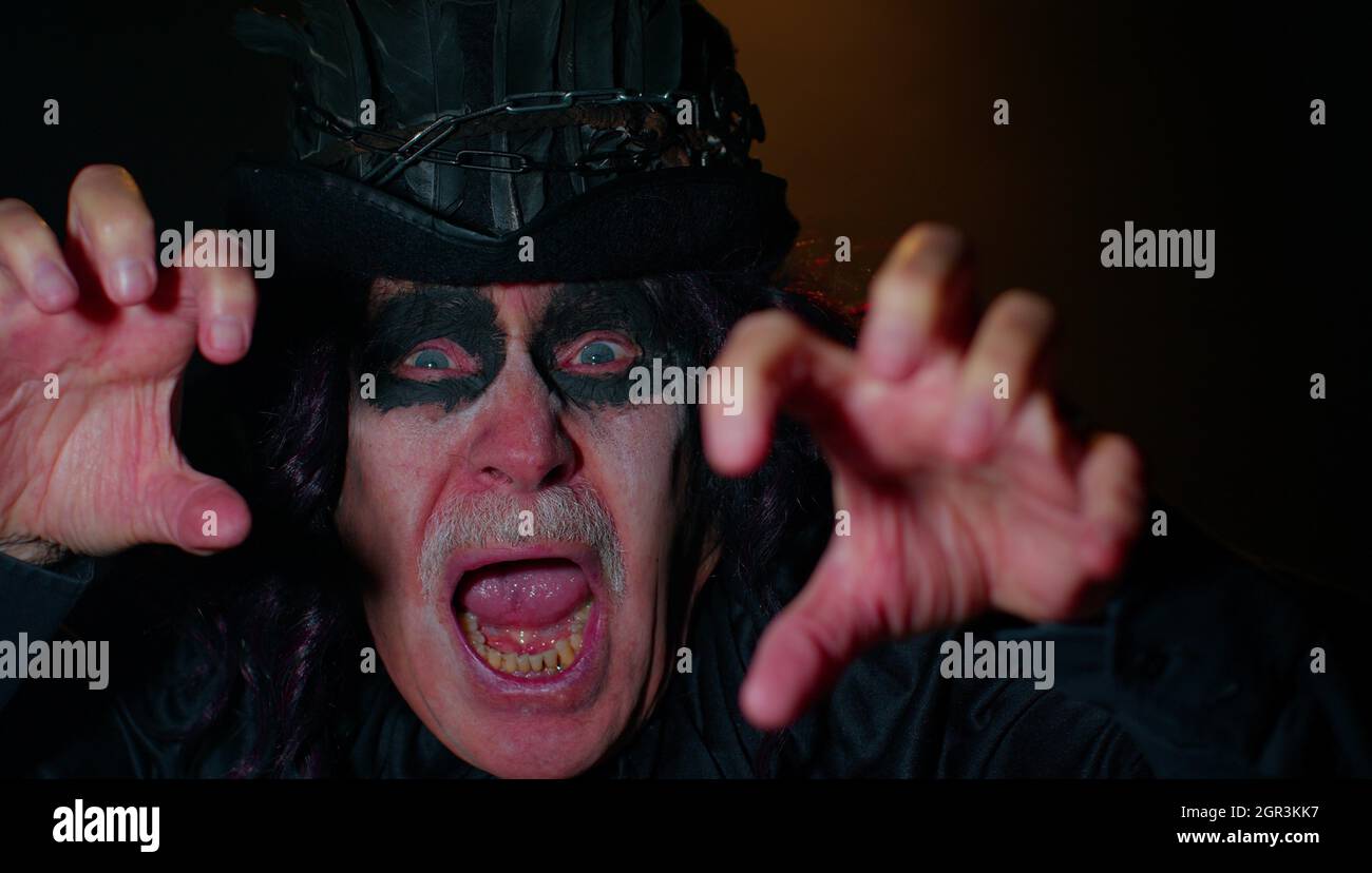 Sinister man with horrible scary Halloween witcher makeup in costume ...