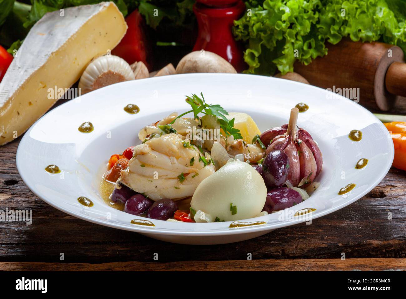 Cod with eggs olives and vegetables Stock Photo - Alamy