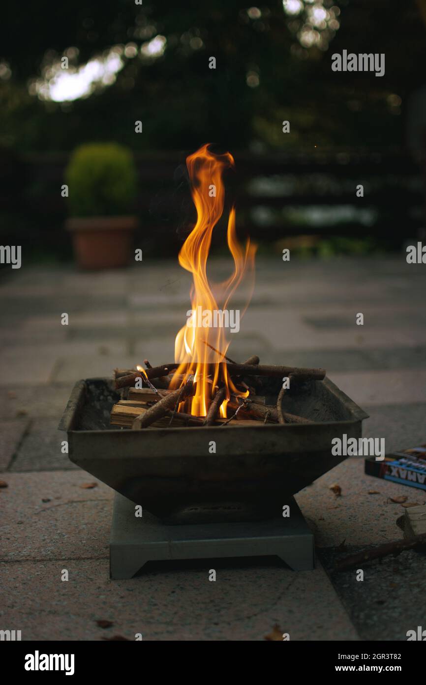 Selective focus of burning sticks on a metal container outdoors Stock ...