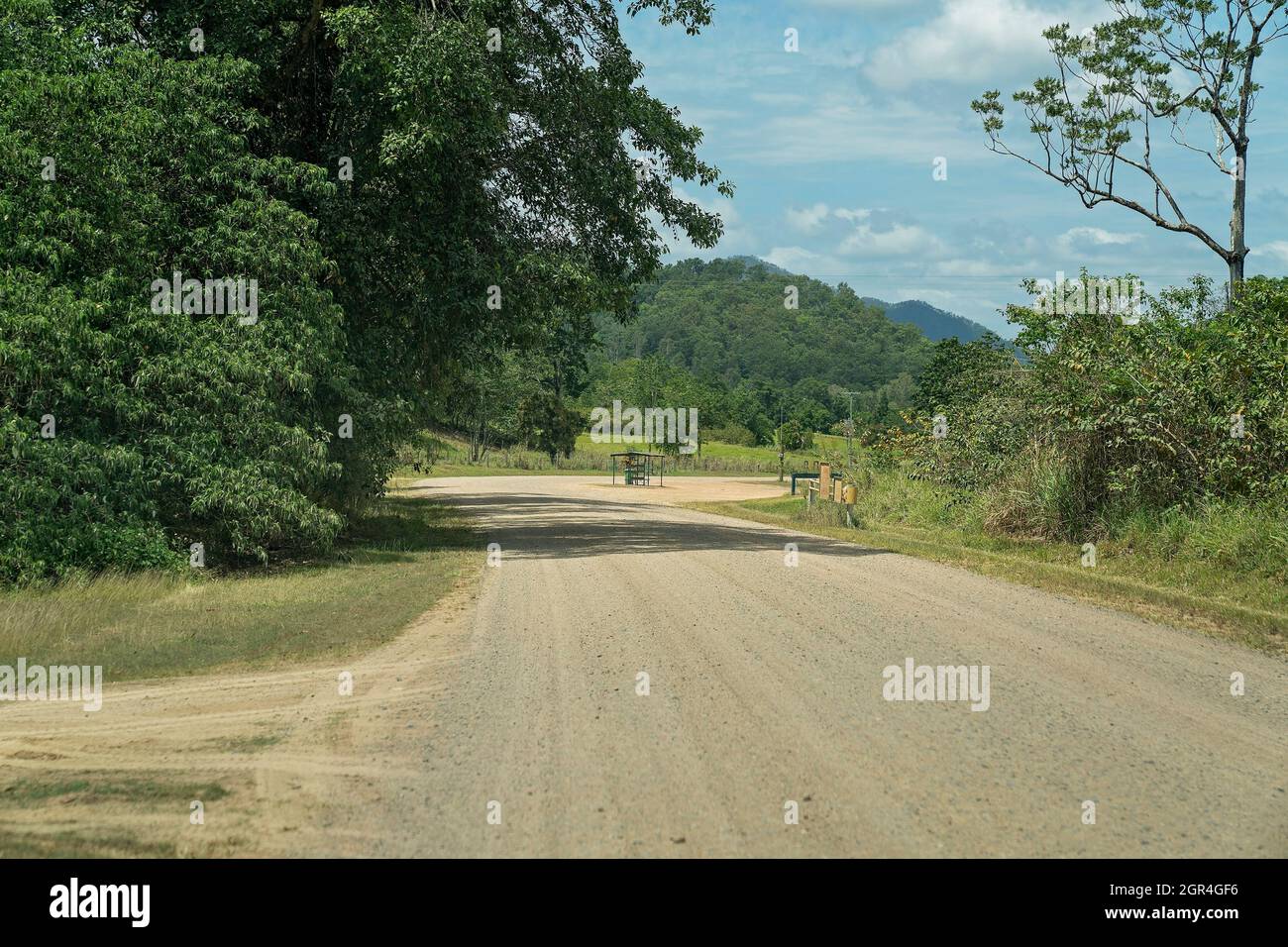 A rural bus shelter at the end of a dusty country road landscape Stock ...
