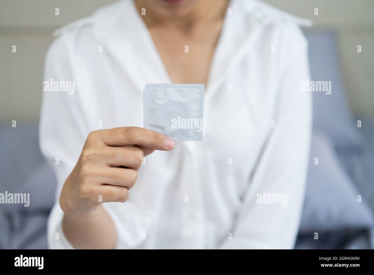 Female hand holding condom hi-res stock photography and images - Alamy
