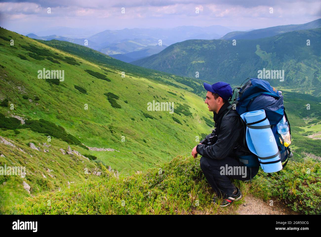 Side View Of Man With Backpack Looking At View Stock Photo - Alamy