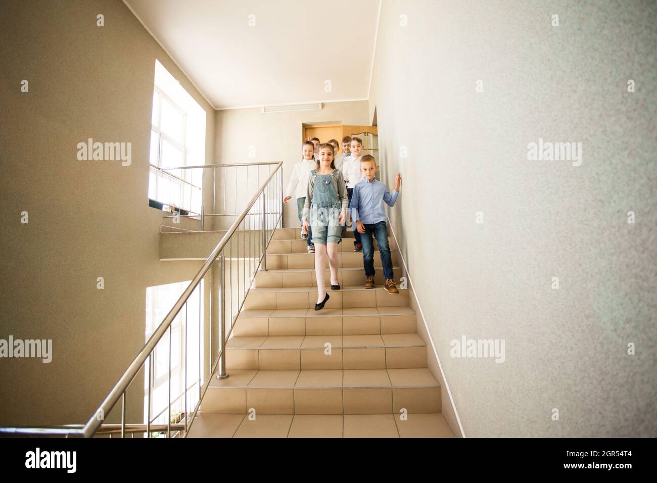 Children Walking On Staircase In Building Stock Photo - Alamy