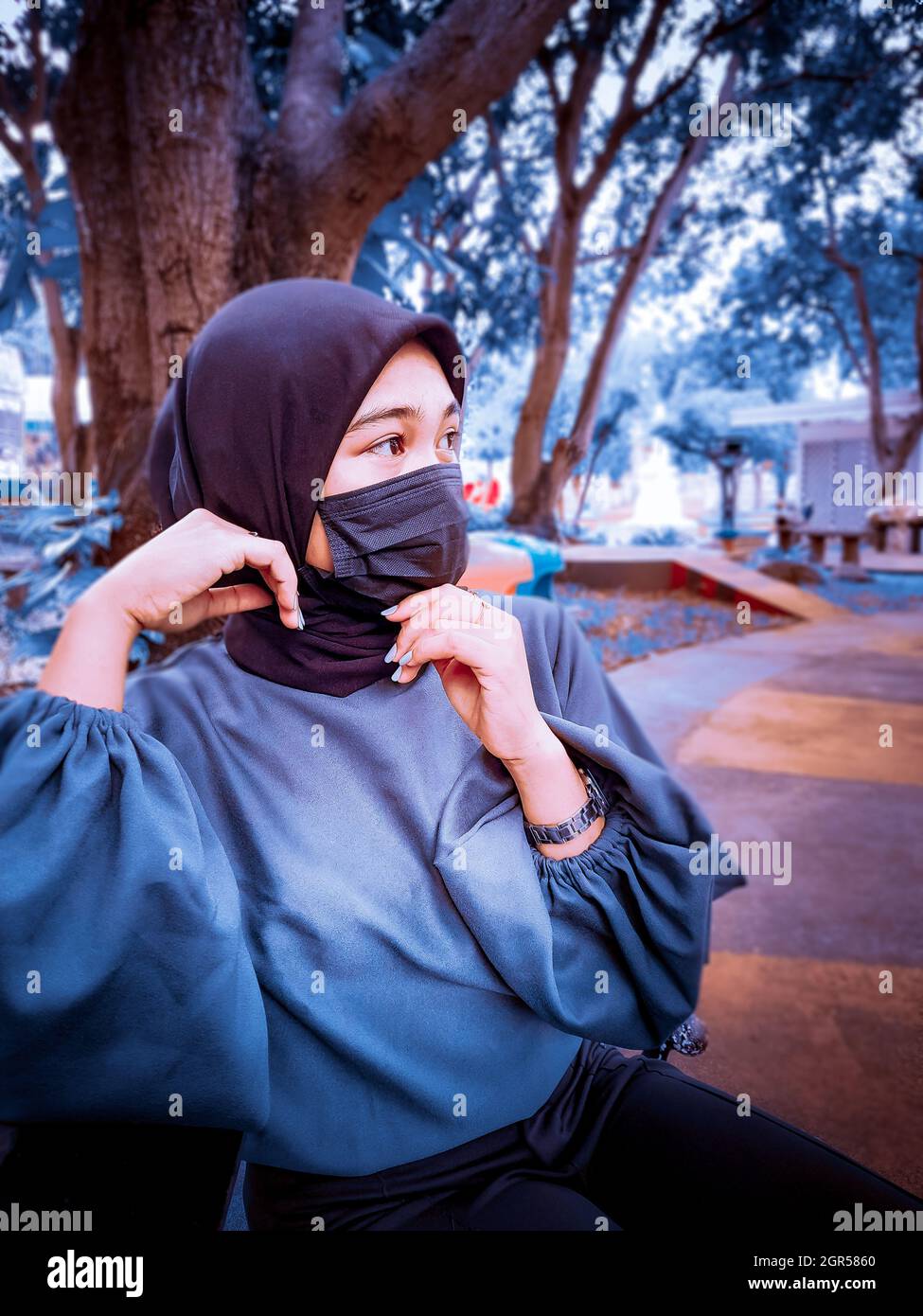 Full Length Portrait Of Man Sitting Against Tree Stock Photo - Alamy