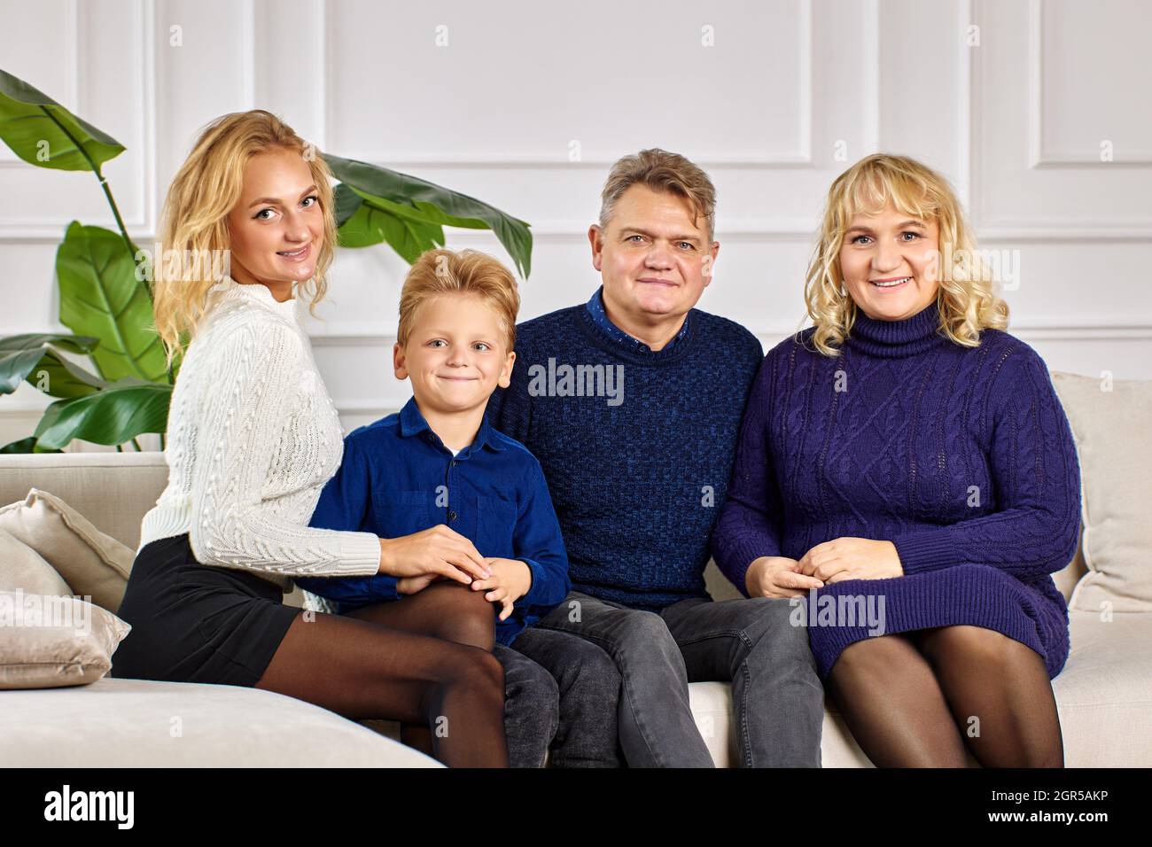 Caucasian family are posing for portrait in living room Stock Photo - Alamy