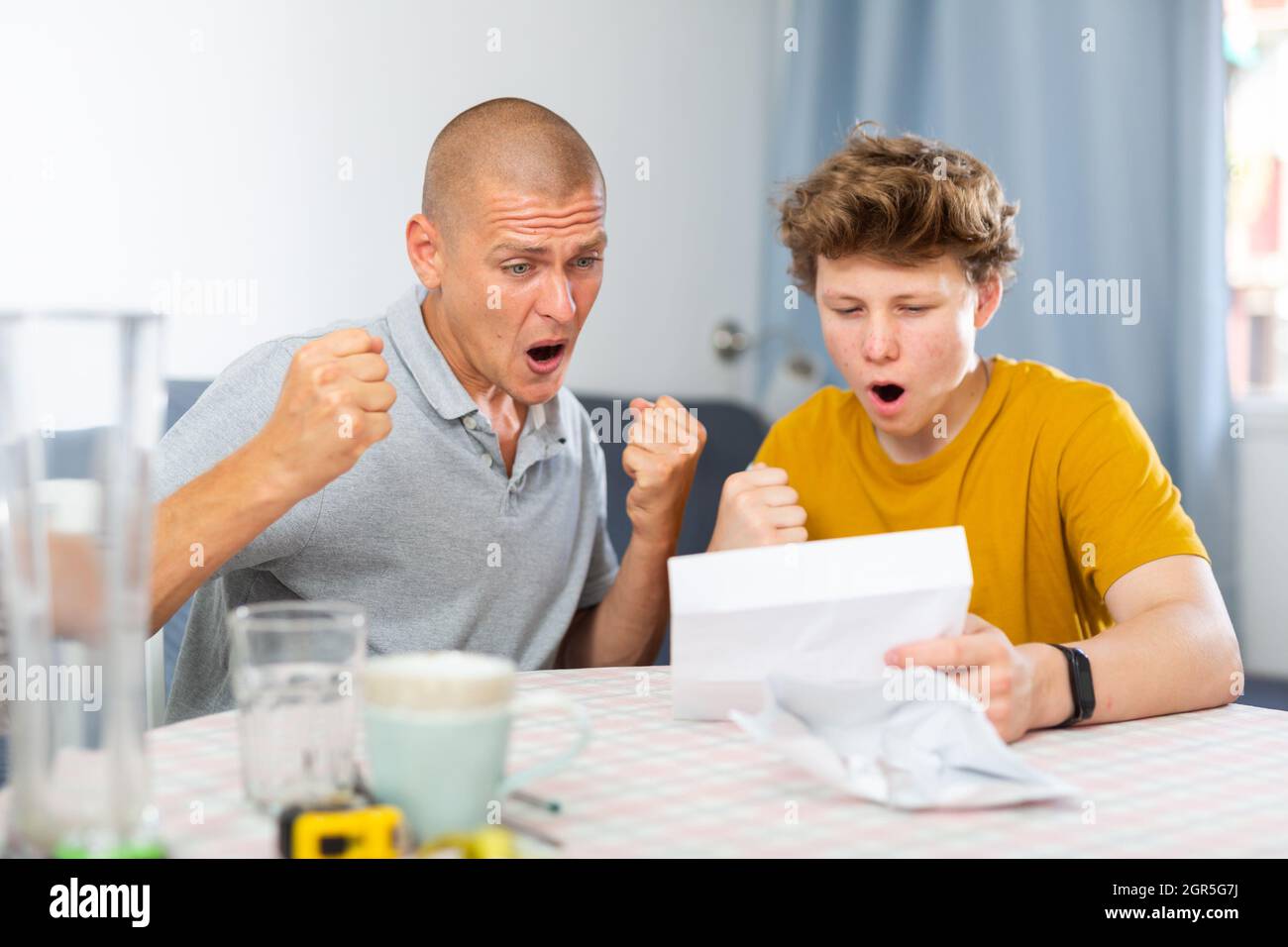 Father congratulates his son after reading letter from college Stock ...
