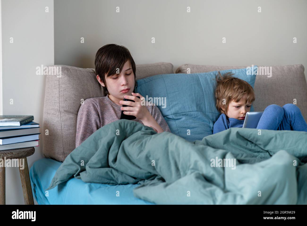 Two boys chatting indoors hi-res stock photography and images - Alamy