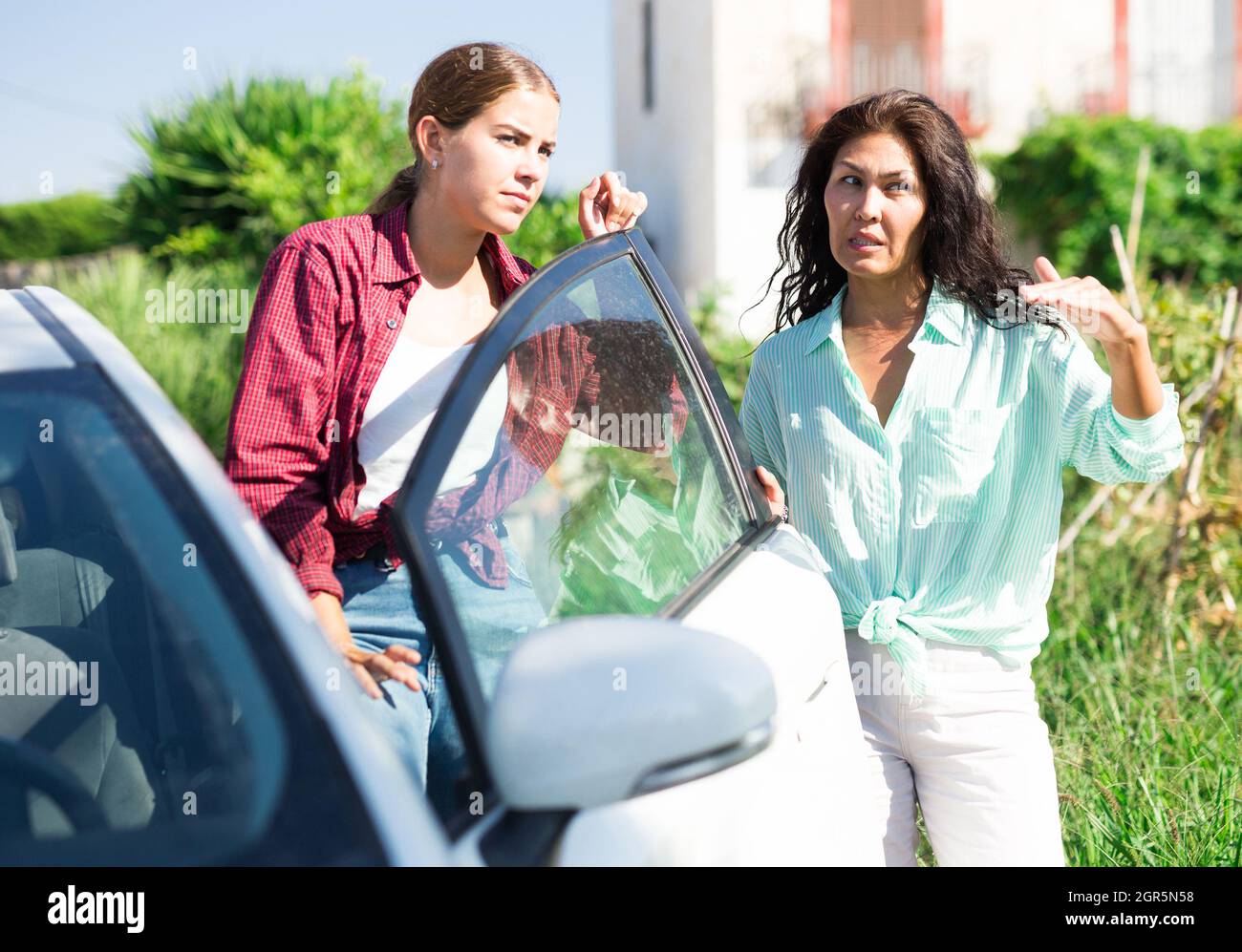 Woman showing way to young lady Stock Photo - Alamy