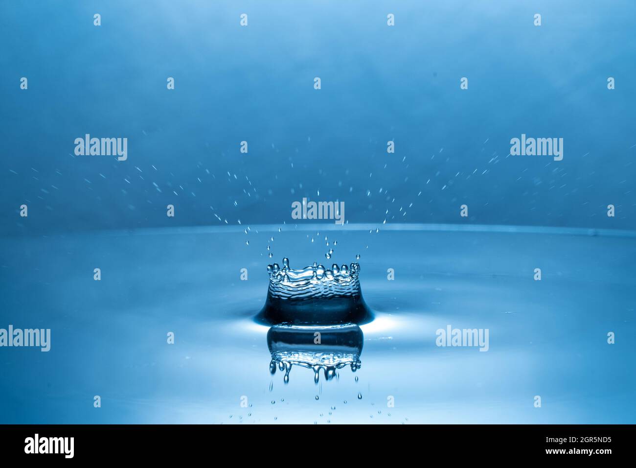 Closeup of water drop splash under the lights - perfect for wallpapers ...