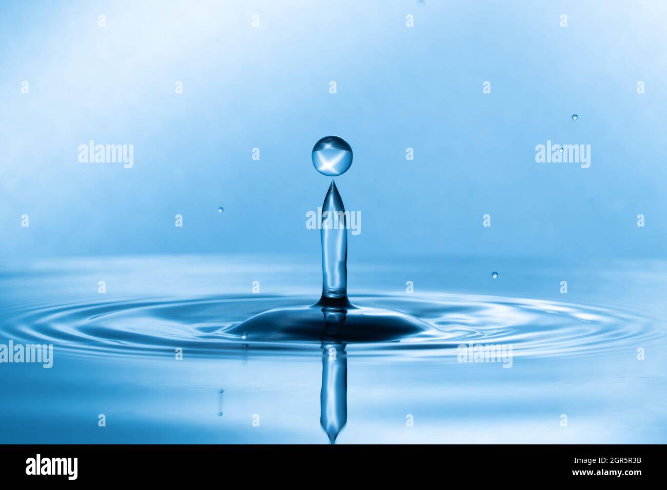 Closeup of water drop splash under the lights - perfect for wallpapers ...
