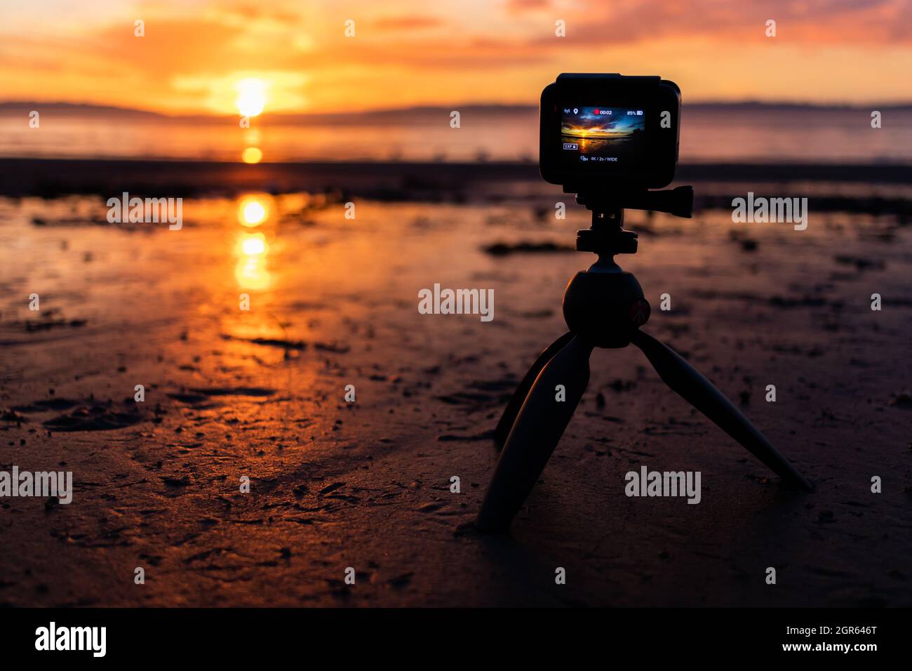 Closeup shot of a Go Pro camera on the sands of the beach, recording ...