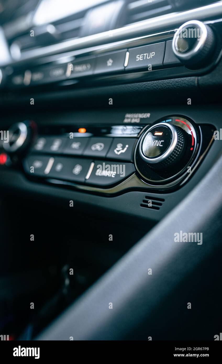 Vertical shot of a heat control panel of a modern car under the lights ...