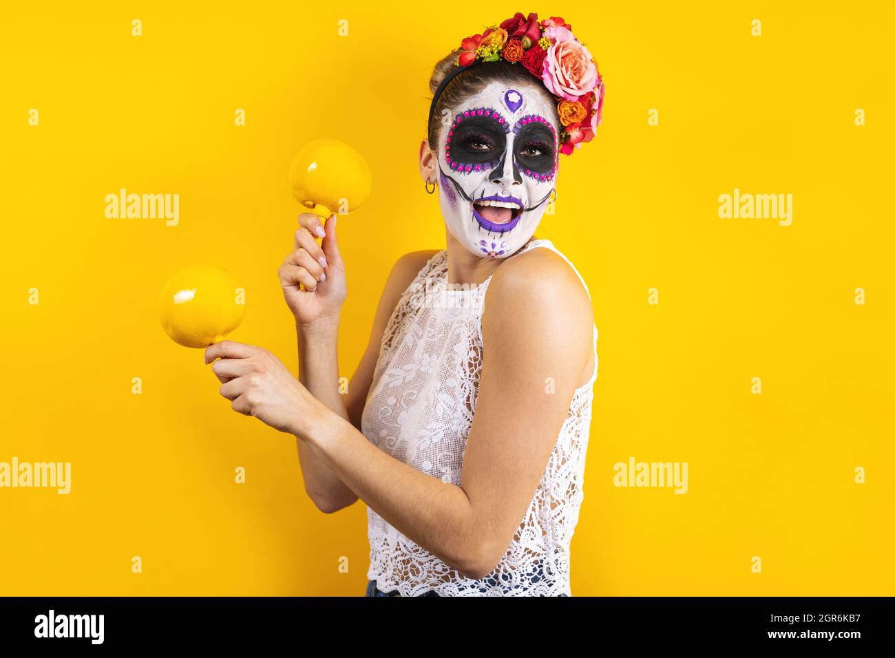 Mexican Catrina, portrait of young latin woman holding mexican maracas ...