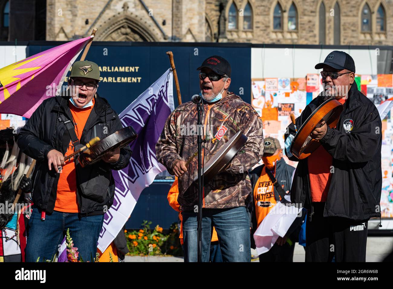 Three First Nations drummers sing and play during the opening of the ...