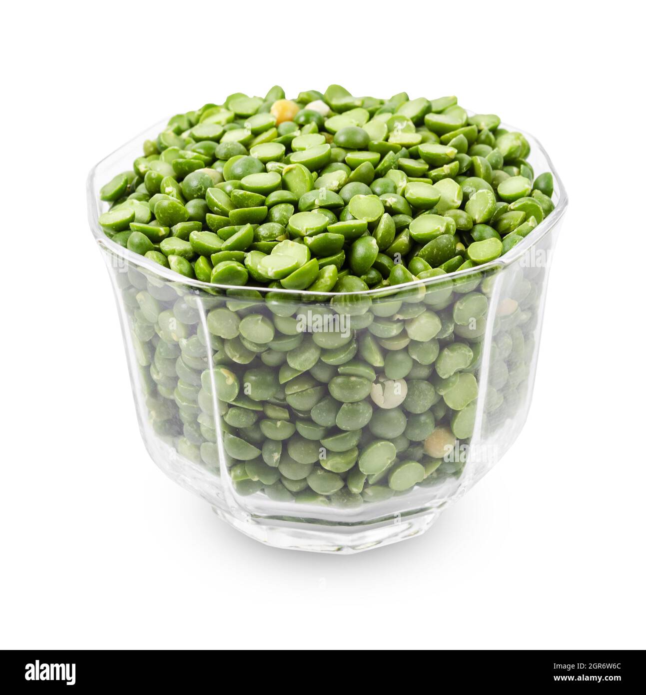 Organic green split peas filling a small bowl isolated on a white ...